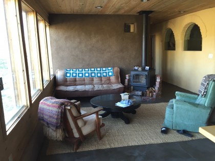 Living Off the Grid in an Eco-Friendly “Earthship” - Living Room Realty